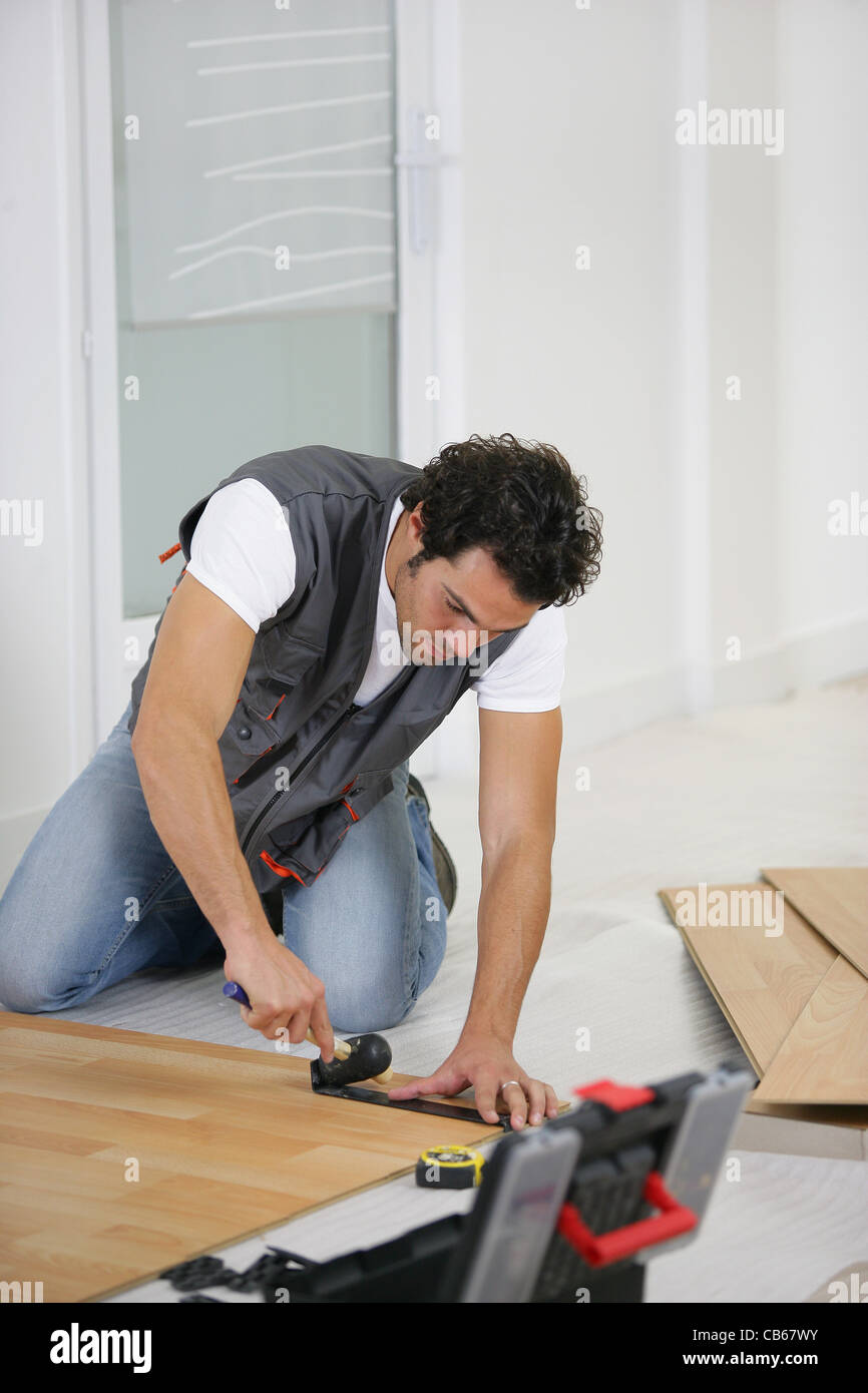 Man laying a wooden floor Stock Photo - Alamy