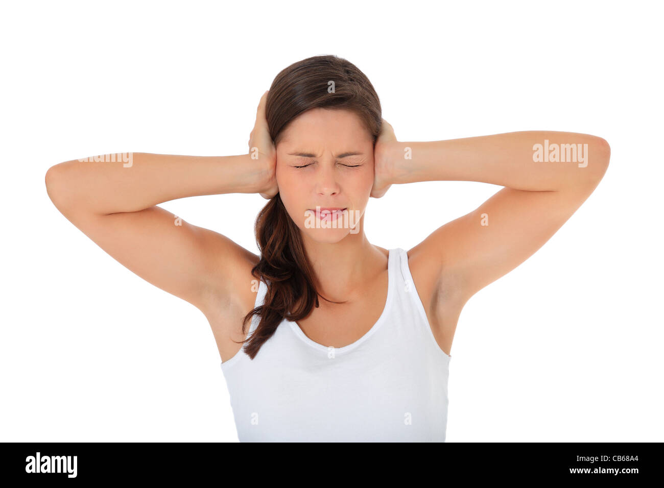 Attractive young woman keeping her ears shut. All on white background ...