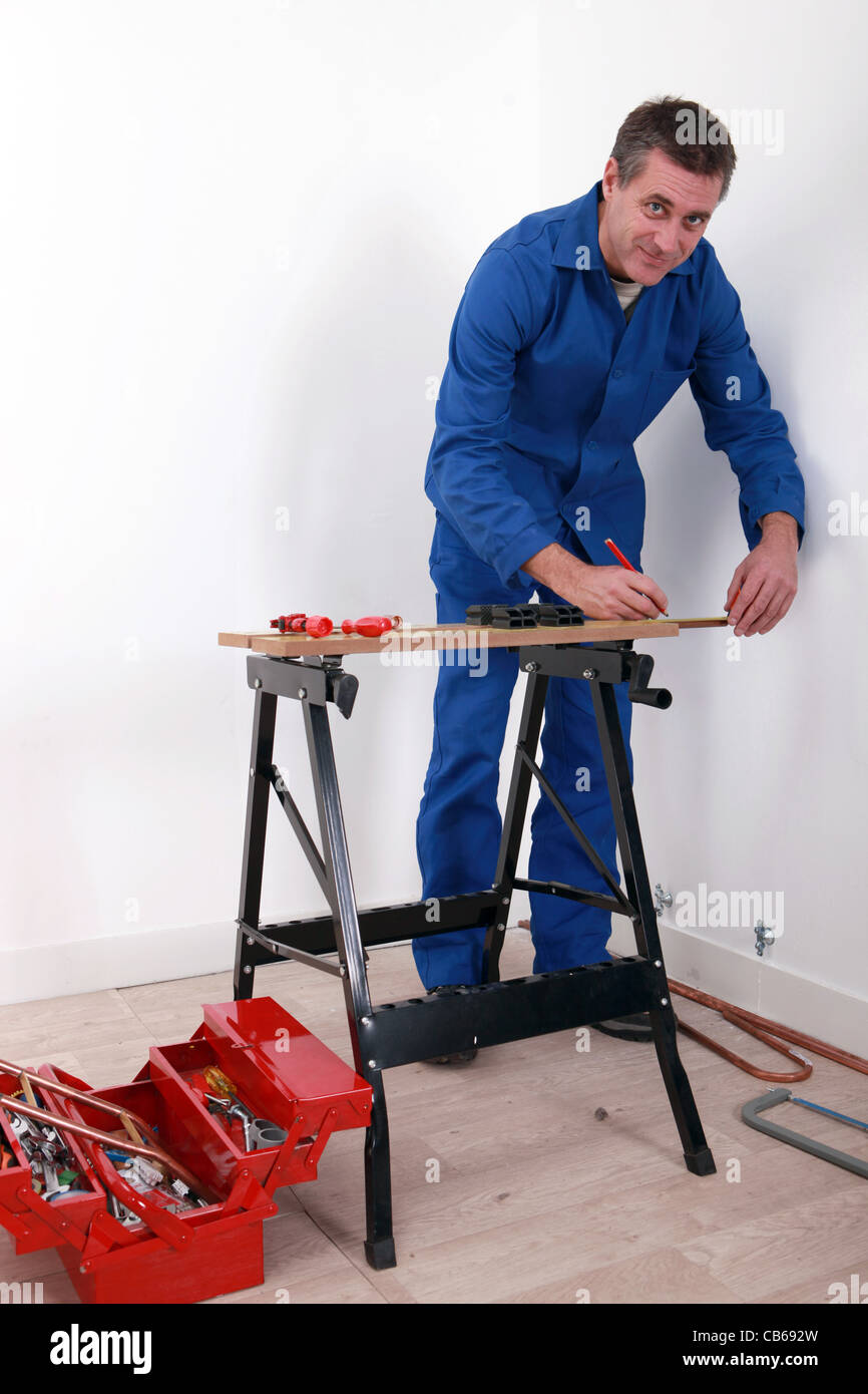 Man working on a workbench Stock Photo - Alamy