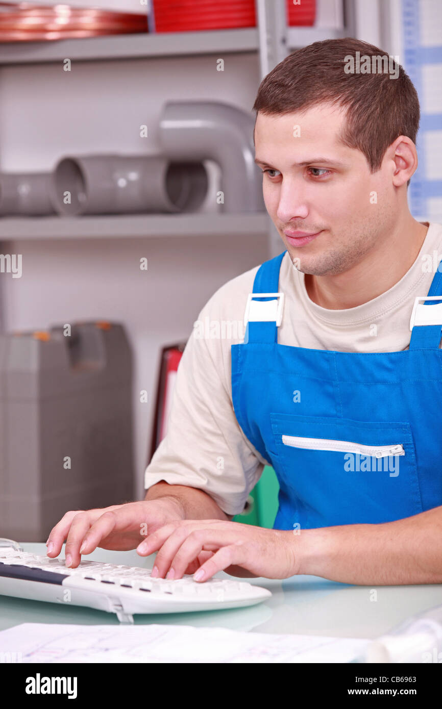 Plumber working in the office Stock Photo - Alamy