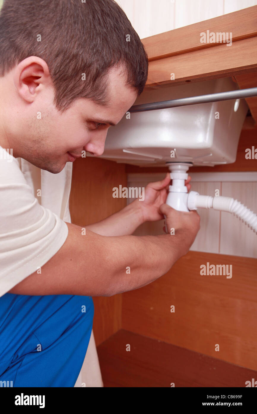 plumber, connecting, pipe under sink Stock Photo - Alamy
