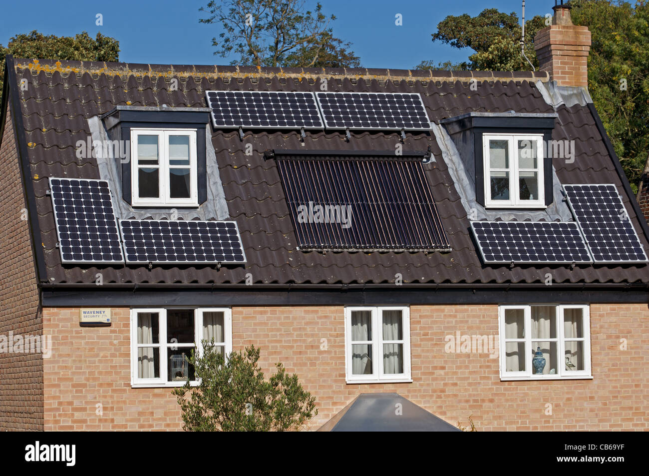 Solar energy panels fitted the the roof of a British home Stock Photo ...