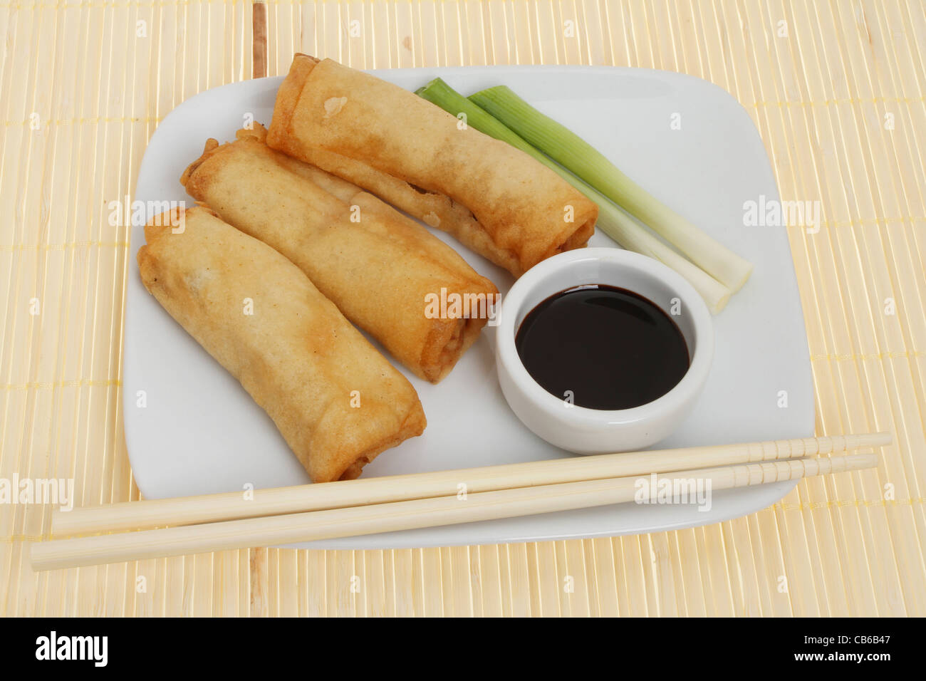 Chinese pancake rolls with spring onions and soy sauce on a plate with ...
