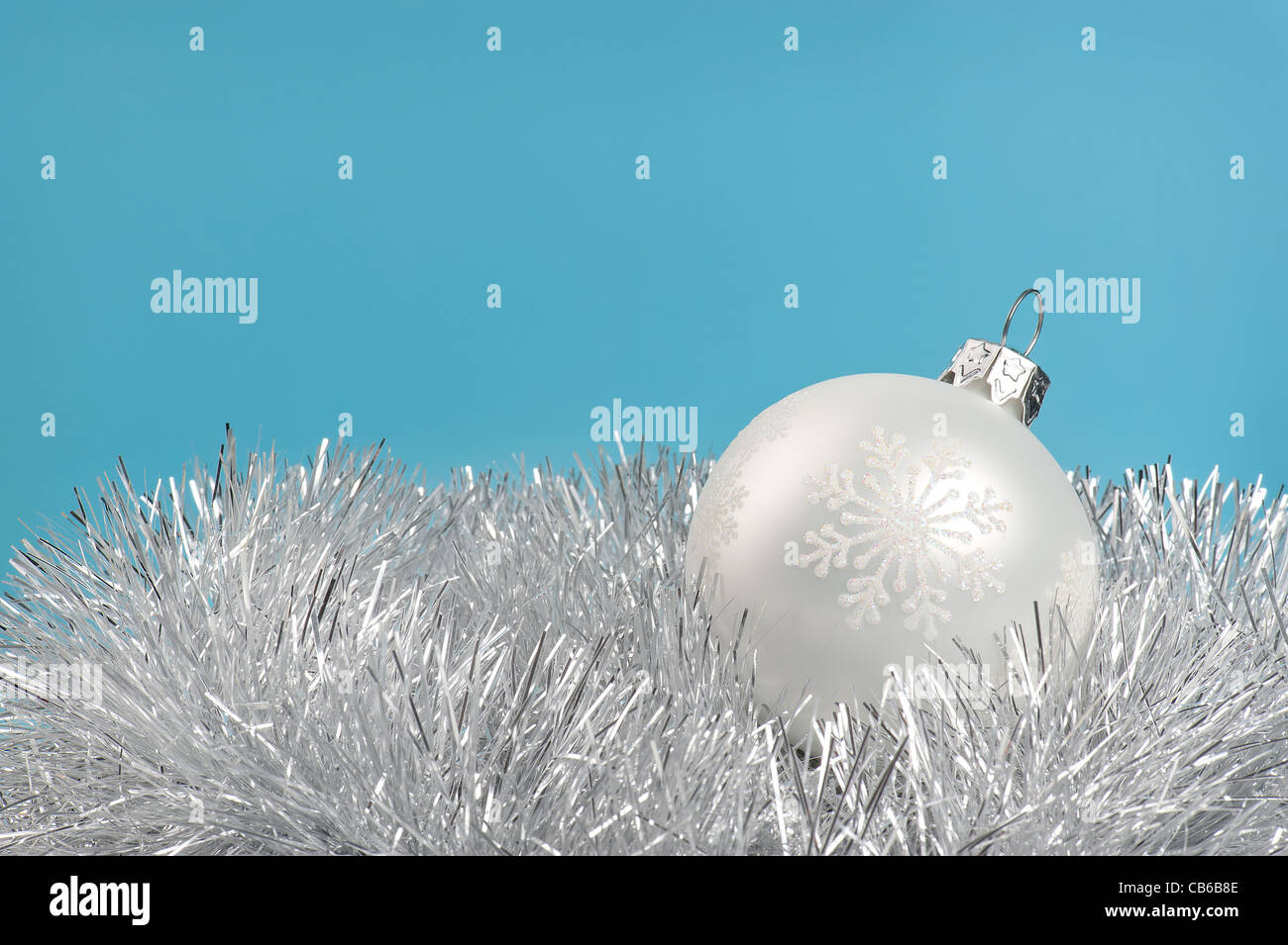 Christmas bauble over light blue background Stock Photo - Alamy
