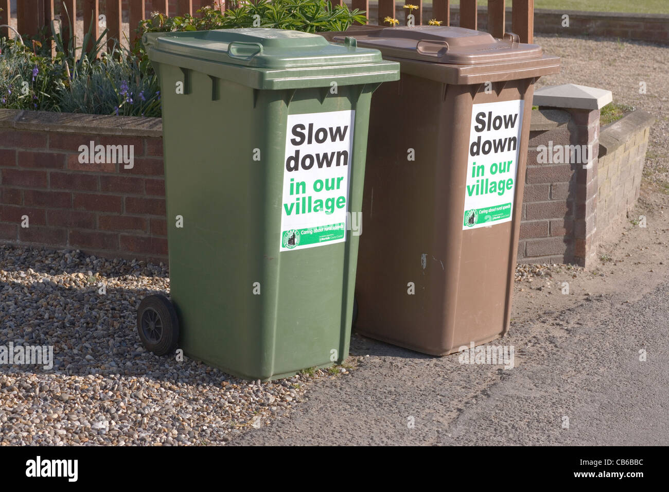 'Slow Down in our Village'; signs attached to local council re-cycling ...