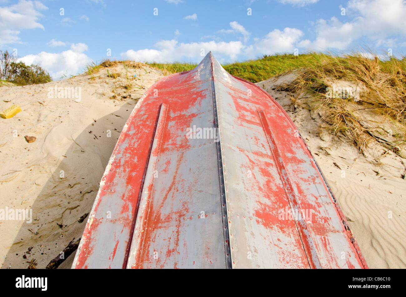 Boat made of tin upside down resting on the dunes. Water transportation ...