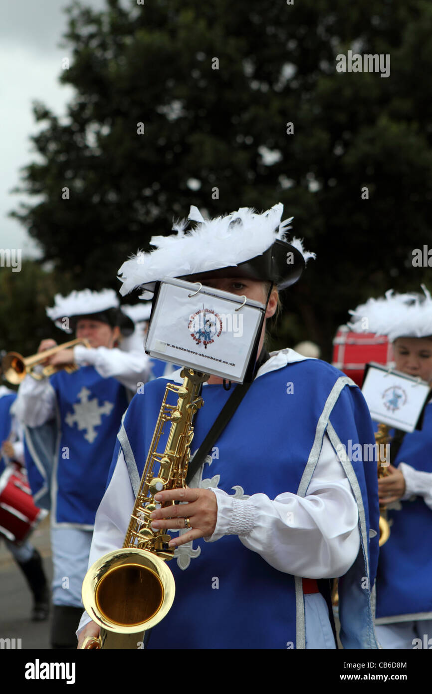 People dressed up in costumes and playing musical instruments during ...