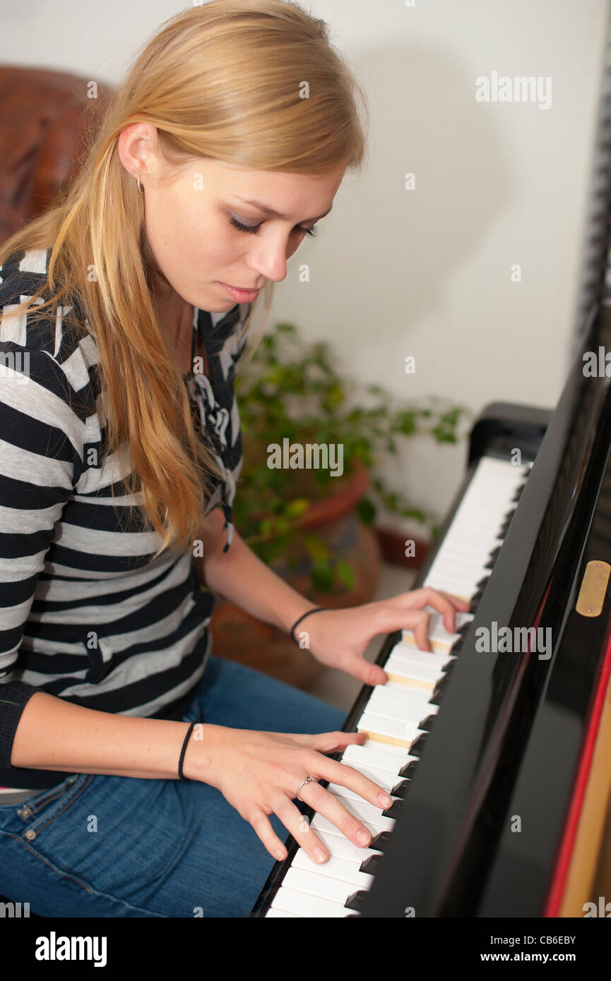 Young woman playing piano Stock Photo - Alamy