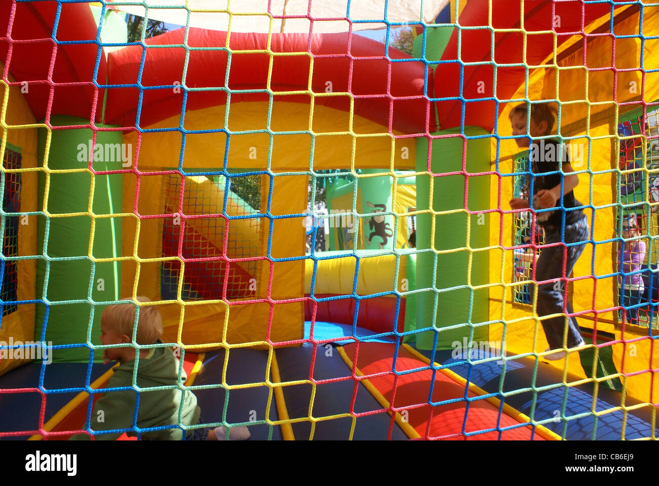 Boys jumping in an enclosed inflatable Stock Photo - Alamy