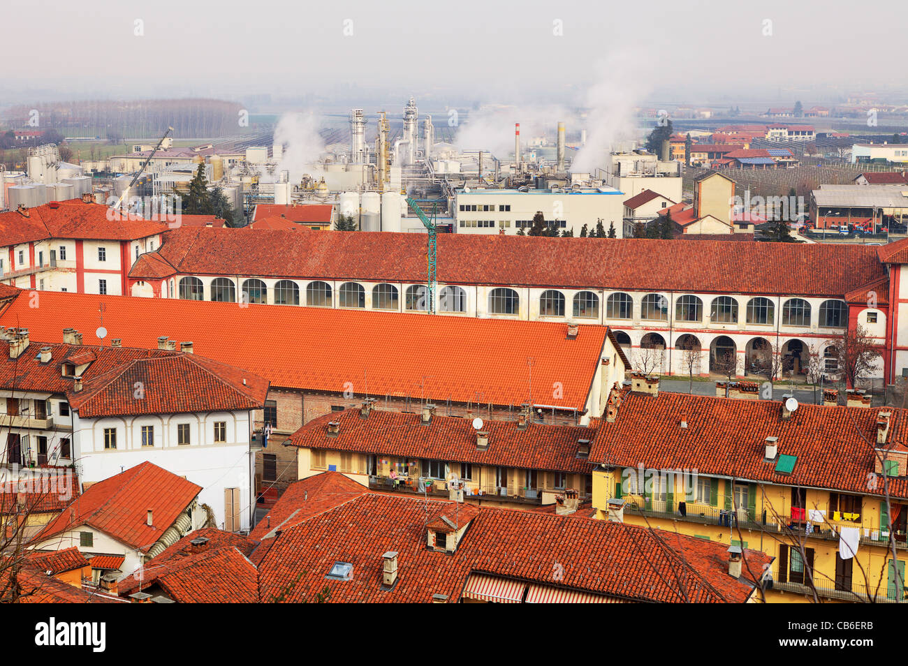 Aerial view on red roofs of residential houses and factory against ...