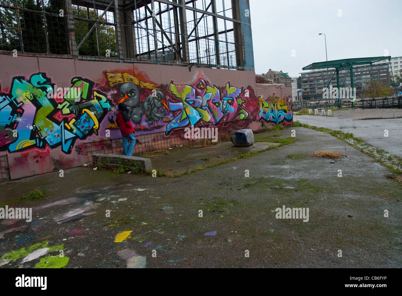 Man walking past graffiti wall hi-res stock photography and images - Alamy