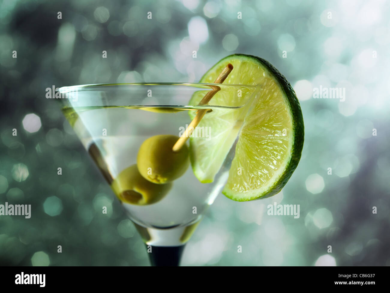 martini with lime and green olives,focus on a lime Stock Photo - Alamy