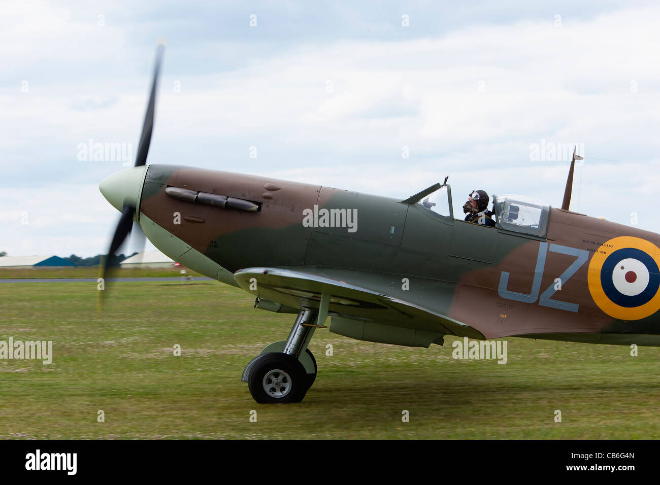 A world war two spitfire aircraft taxies past the crowds at an airshow ...