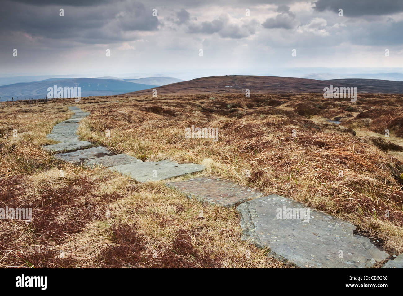 Stone path on the route down from Cheviot along the Pennine Way toward ...