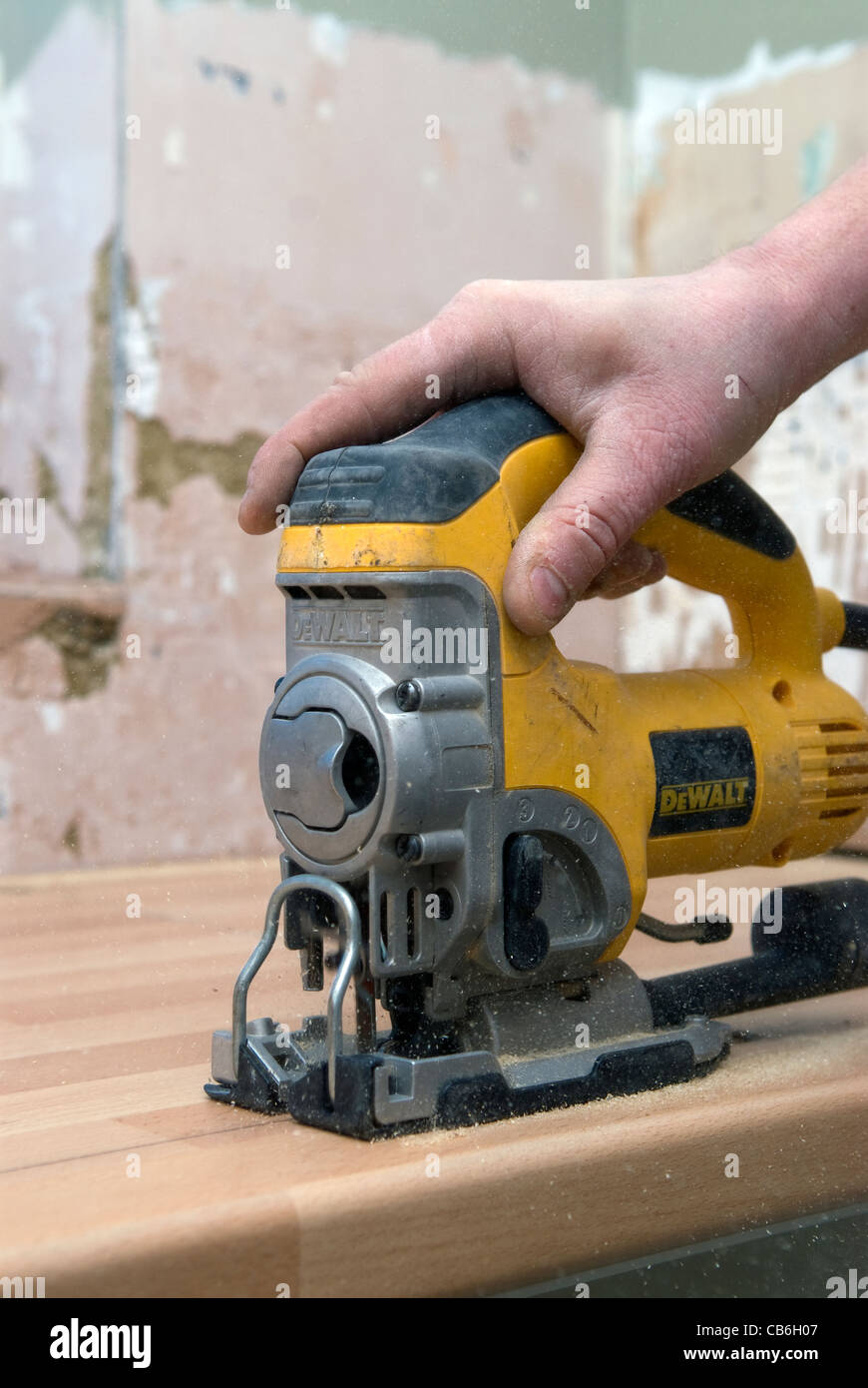 sman-using-a-jigsaw-for-fitting-a-new-kitchen-worktop-in-stock-photo-alamy