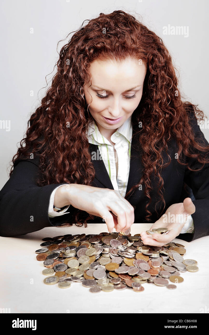 woman at her desk at work counting money (English coins Stock Photo - Alamy