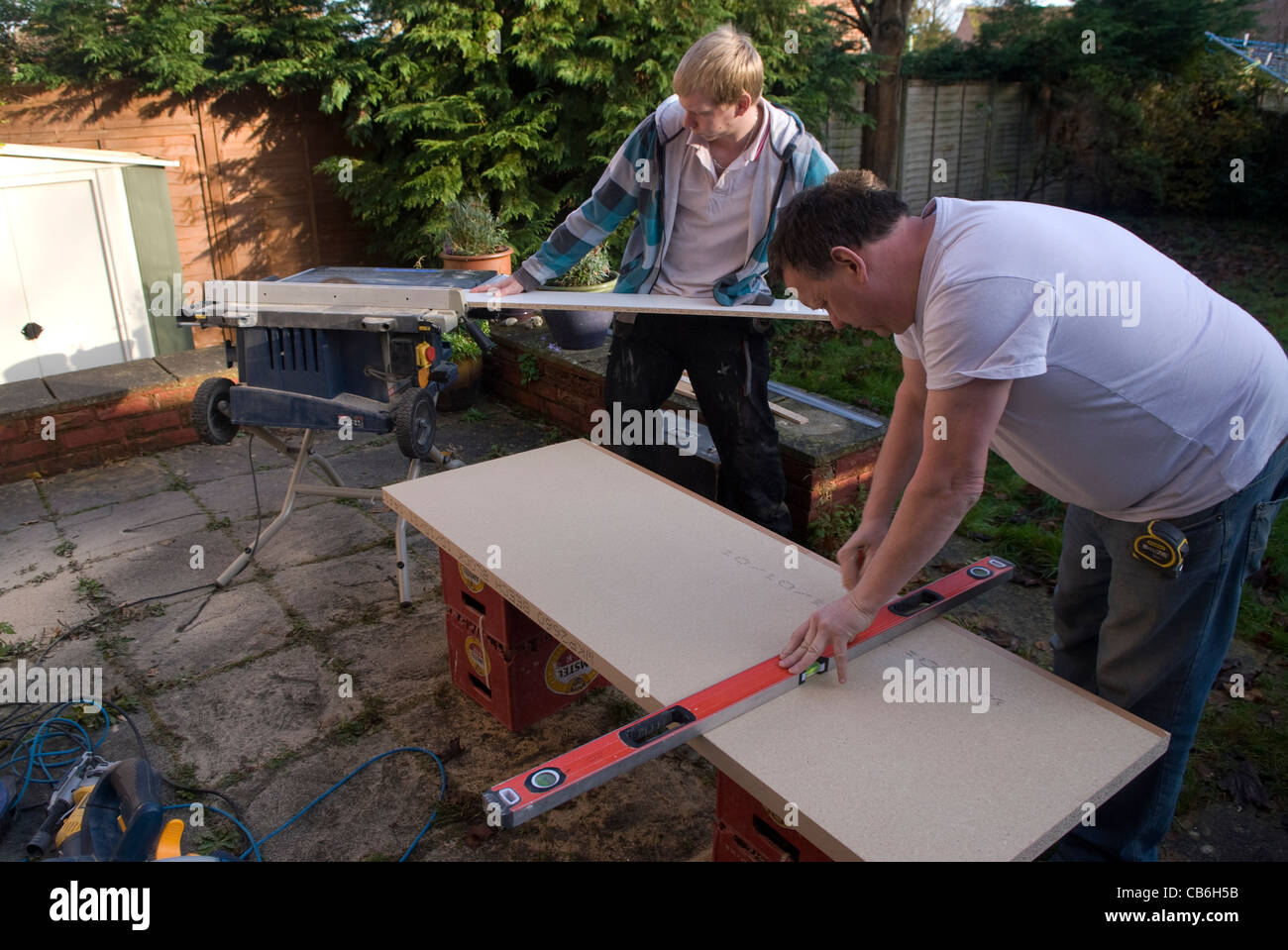 Kitchen fitters measuring & cutting units for installation in new ...