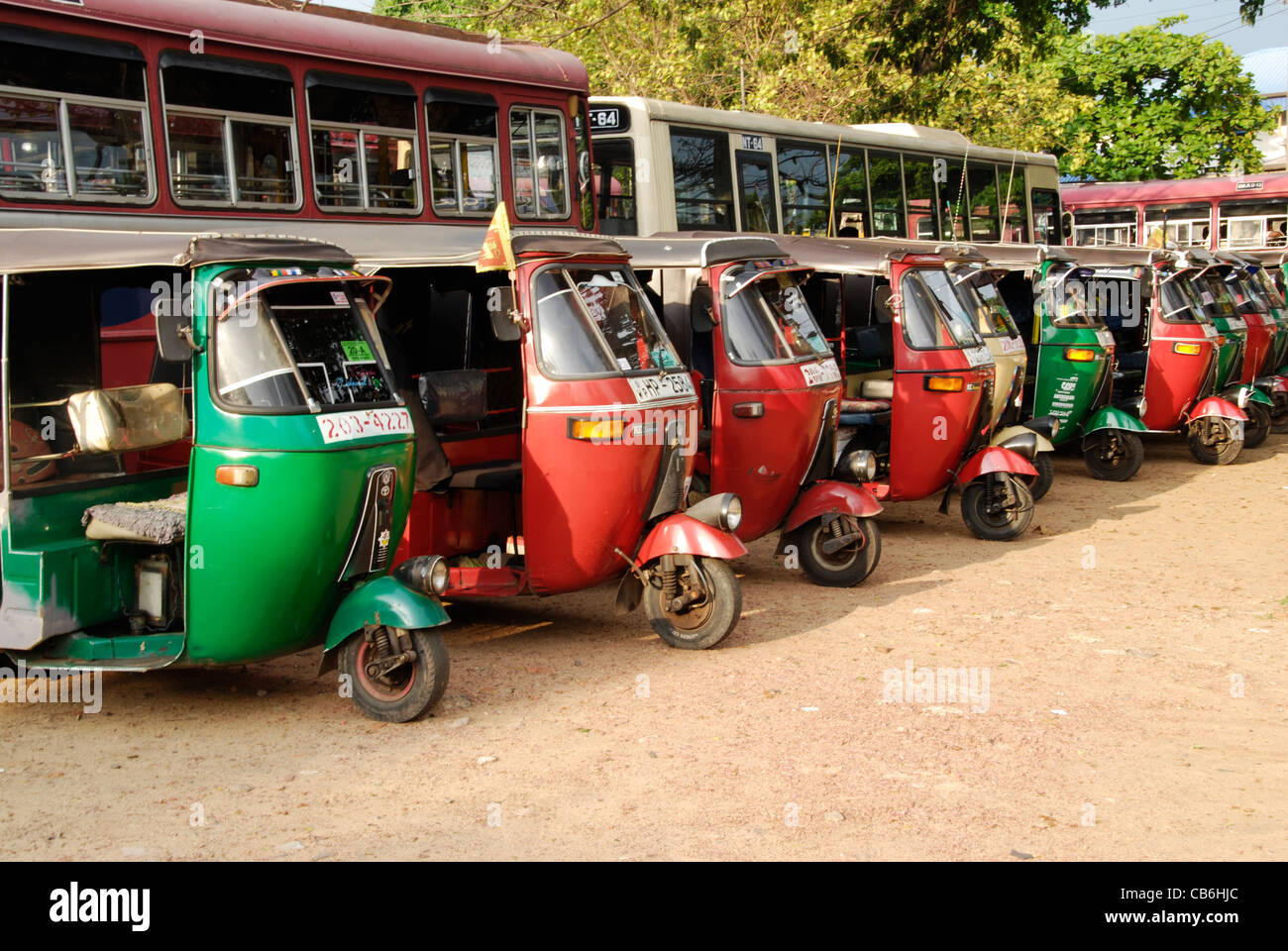 Row of traditional Asian tuk tuk taxis standing near the bus station on ...