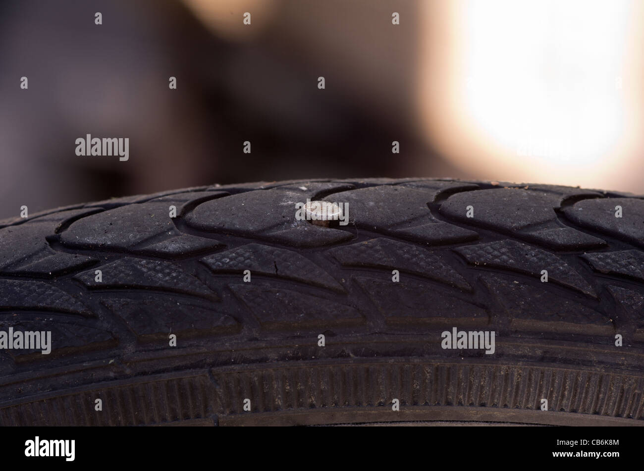 nail deeply penetrates bicycle wheel causing puncture Stock Photo - Alamy