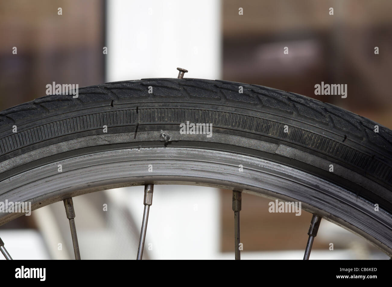 nail deeply penetrates bicycle wheel causing puncture Stock Photo - Alamy