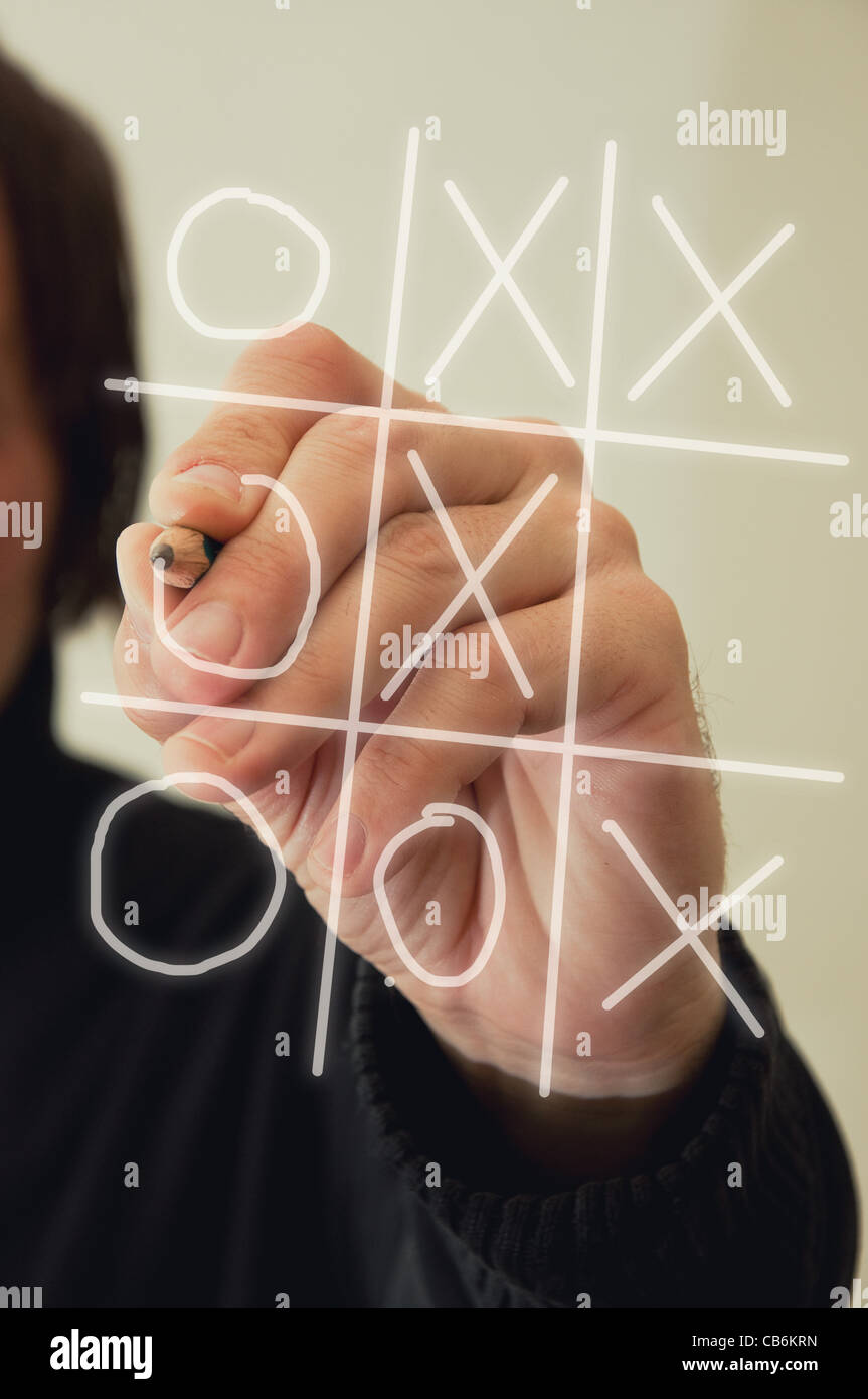 Man playing Tic Tac Toe, a leisure game, on glass board Stock Photo - Alamy