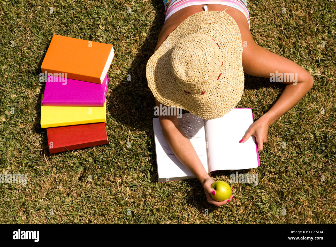 a student relaxing at the grass of the school park (the pages in the ...