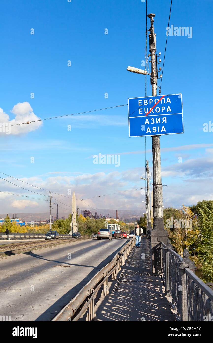 Road sign about Europe and Asia border in Ural river. It is located on vehicular bridge in city ...
