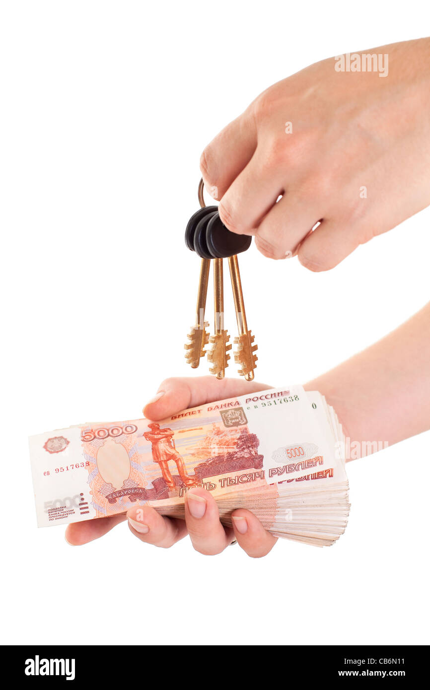 House key in hand and cash money in other hand isolated ob white ...