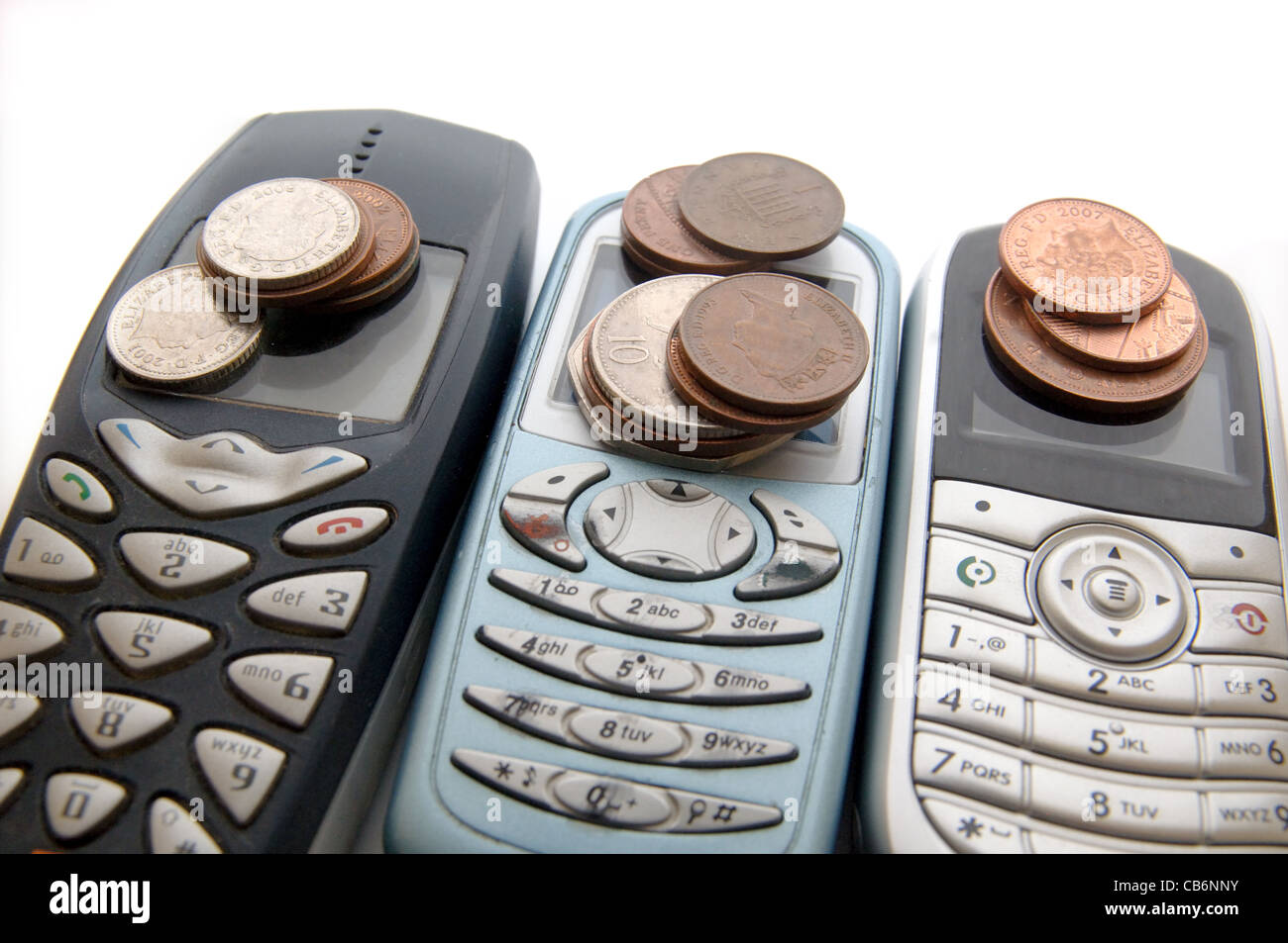 Three mobile phones with money Stock Photo - Alamy