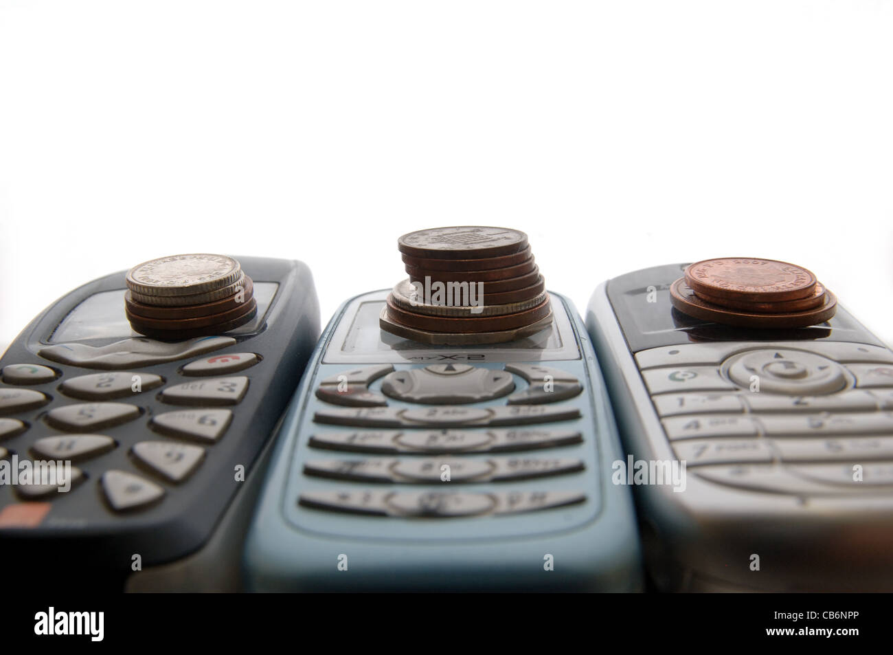 Three mobile phones with money Stock Photo - Alamy