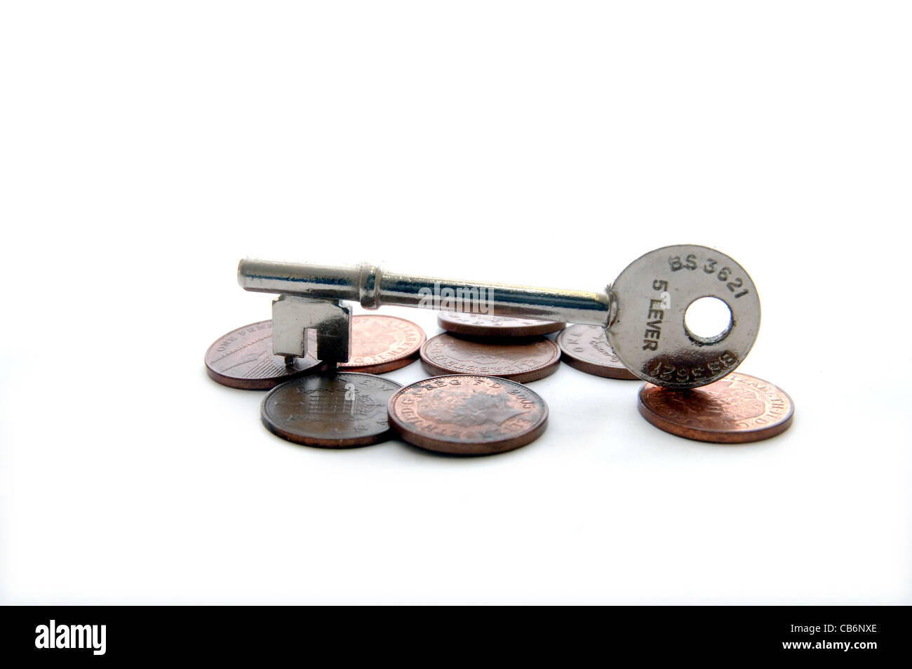 A key with coins Stock Photo - Alamy