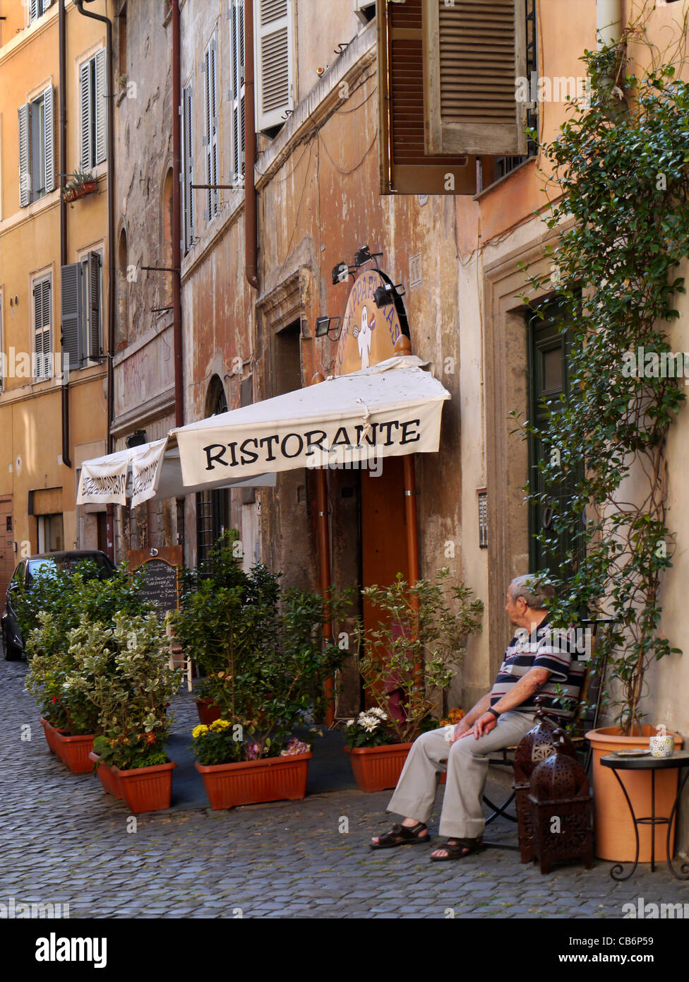 Medieval street in Rome with restaurant awning Stock Photo - Alamy