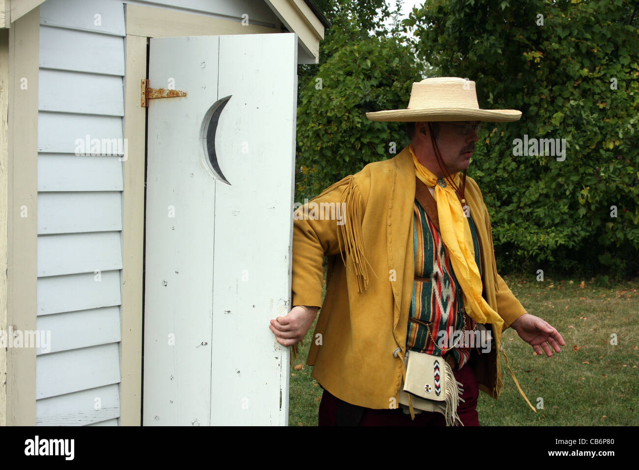 A cowboy exiting an old outhouse Stock Photo - Alamy