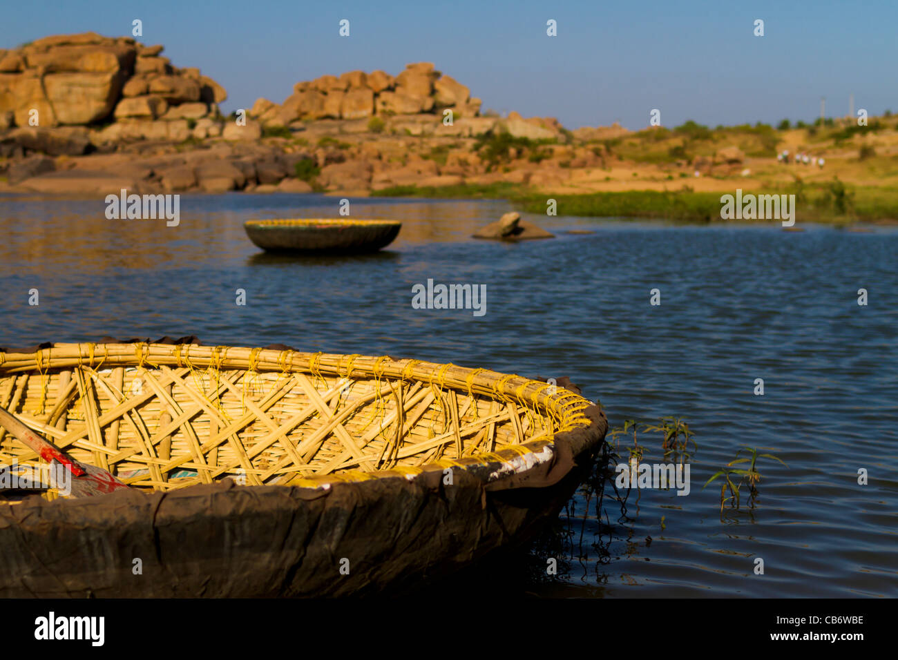hampi ruins rocks water coracle river transport Stock Photo - Alamy