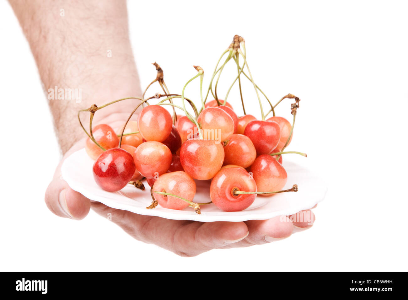 hand with cherry isolated on white background, focus on center Stock ...