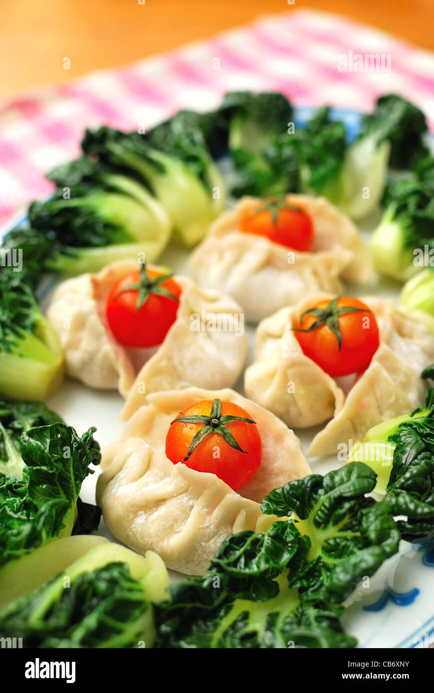 Delicious looking mini tomato dumplings with vegetables Stock Photo - Alamy