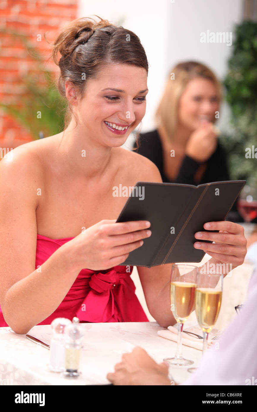 woman looking at the menu at a restaurant Stock Photo - Alamy