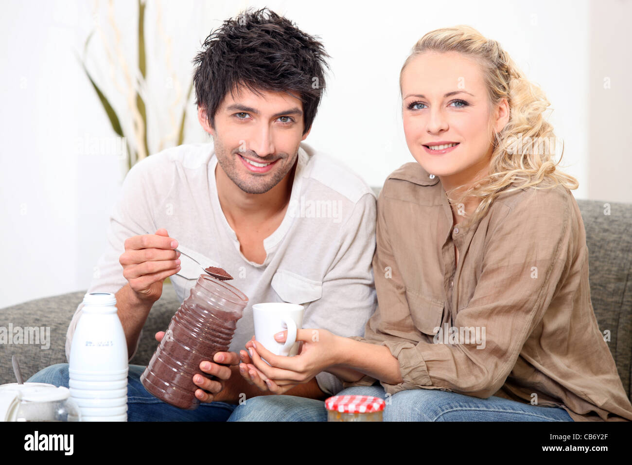 Couple making hot chocolate Stock Photo - Alamy