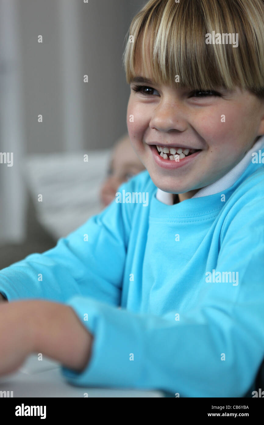 Little boy giggling in class Stock Photo - Alamy