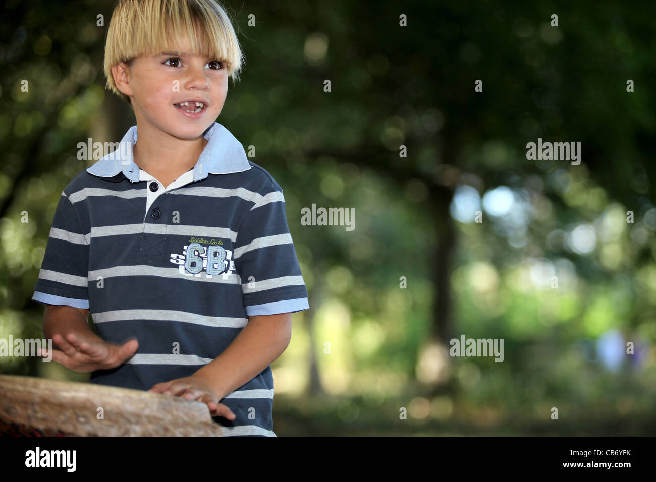 Little boy playing bongo in park Stock Photo - Alamy