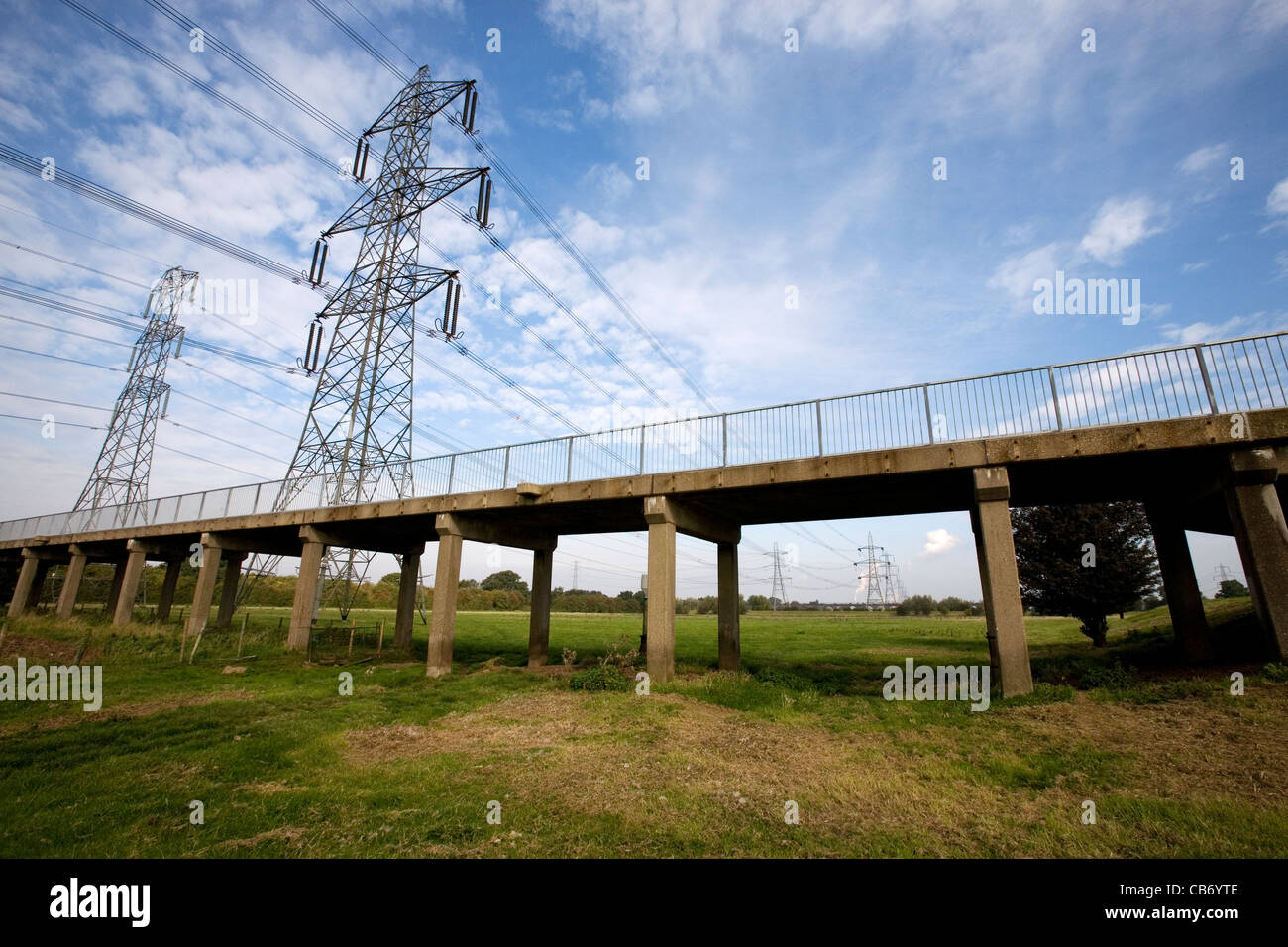 Electricity Pylons and Footbridge Stock Photo - Alamy
