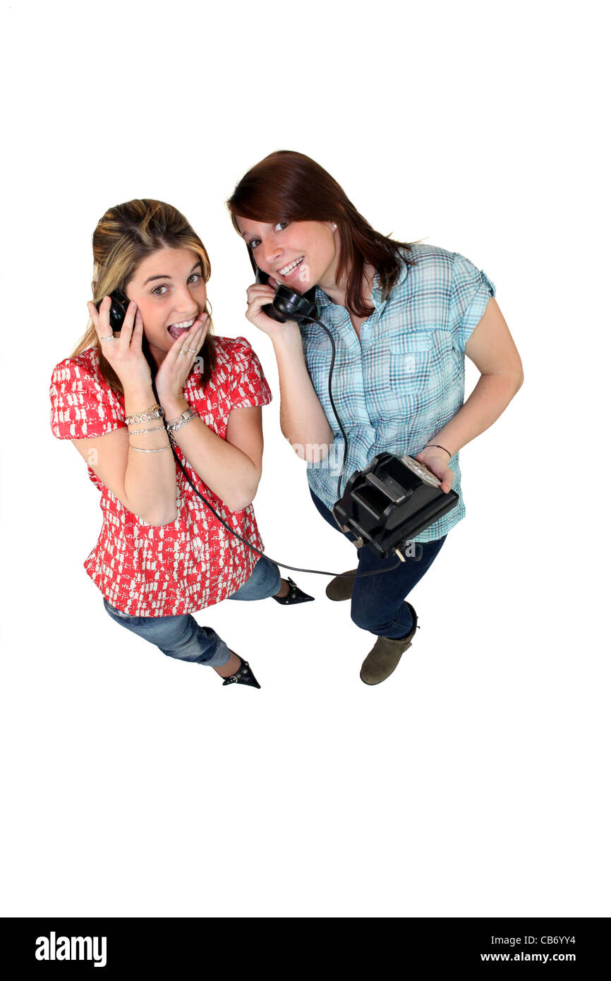 Girls playing with old phone Stock Photo - Alamy