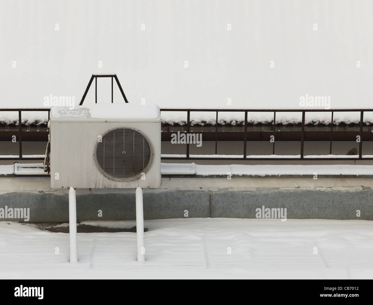 Image of an air conditioner machine on a roof of a building covered by ...