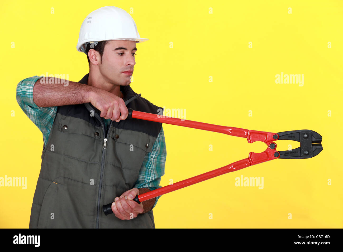Tradesman holding large clippers Stock Photo - Alamy