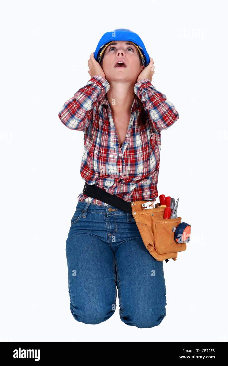 A female construction worker covering her ears Stock Photo - Alamy