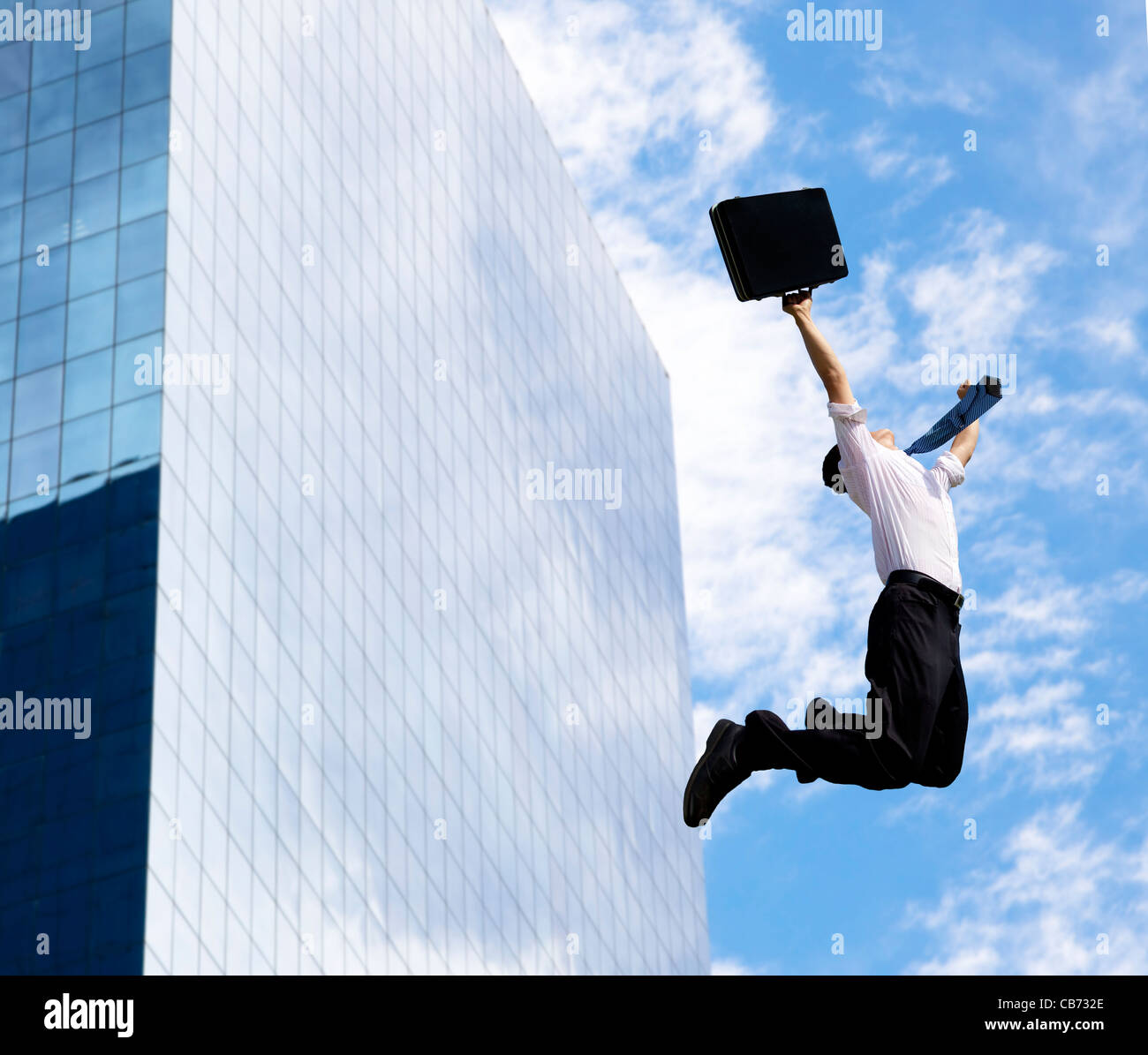 happy businessman jumping in front of a building Stock Photo - Alamy