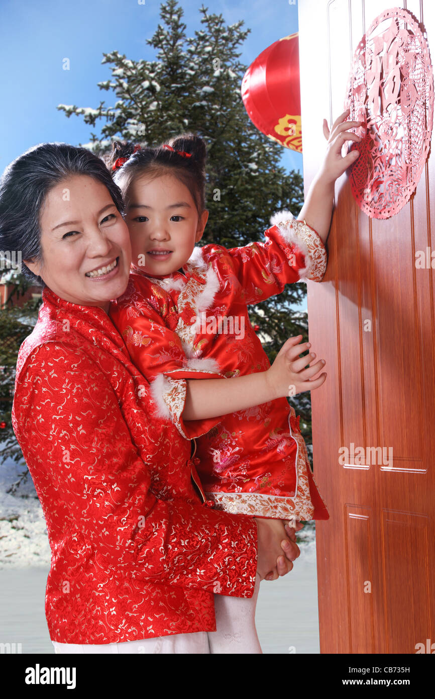 Granddaughter greeting grandmother front door hi-res stock photography ...