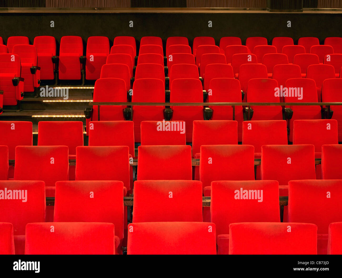 indoor scenery showing a movie theater with red seats in warm ambiance ...