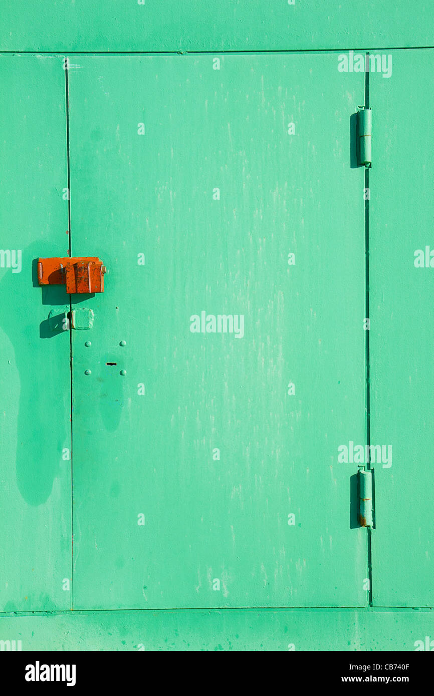 lock on the metal door painted with green paint Stock Photo - Alamy