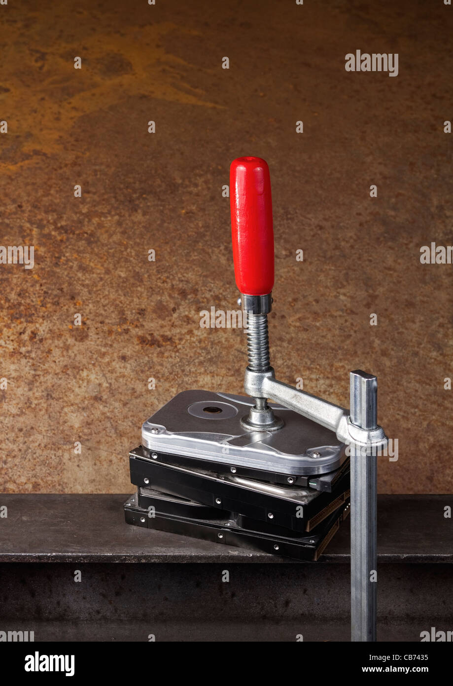 some hard disk drives compressed with a screw clampin rusty back Stock ...
